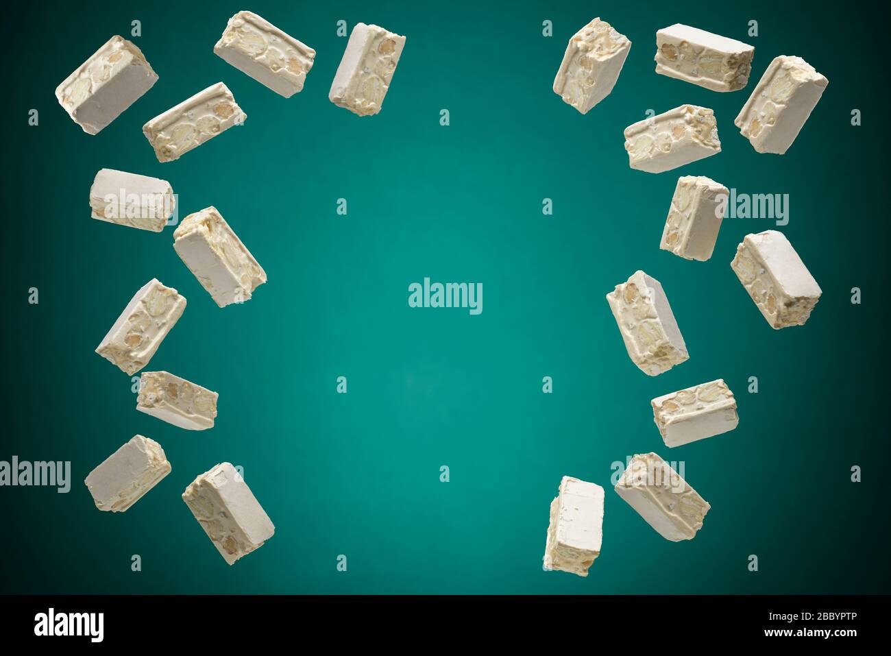 small nougat pieces flying on green background with copy space Stock ...