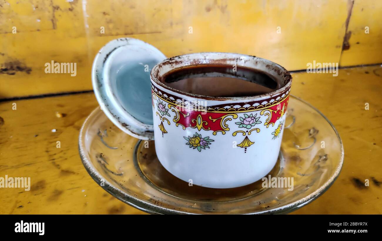 Black coffee is brewed in small glass cups, ready to drink, unfocused ...