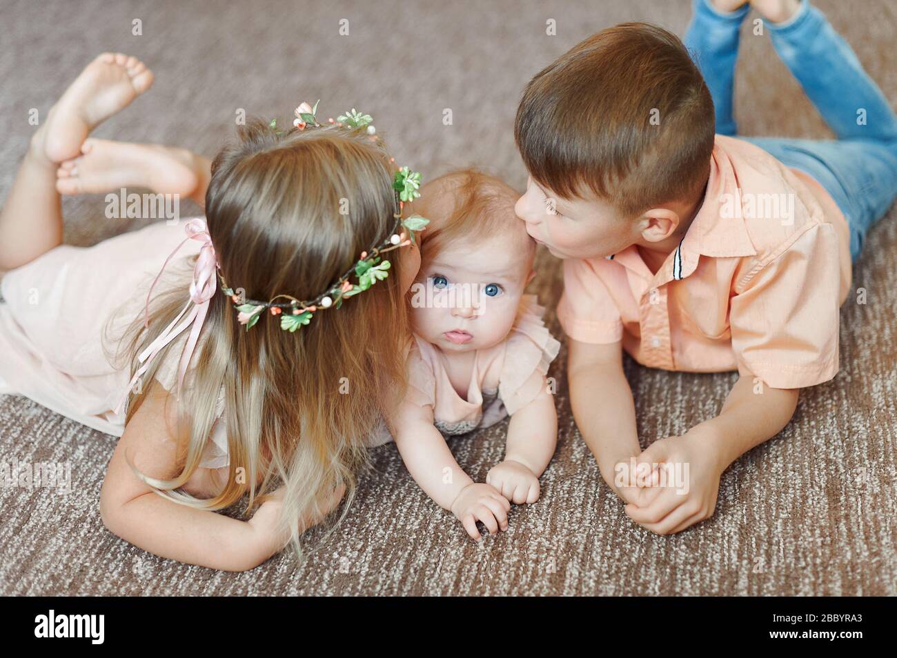 Little Children Together Hangout and Smiling in studio on floor Stock ...