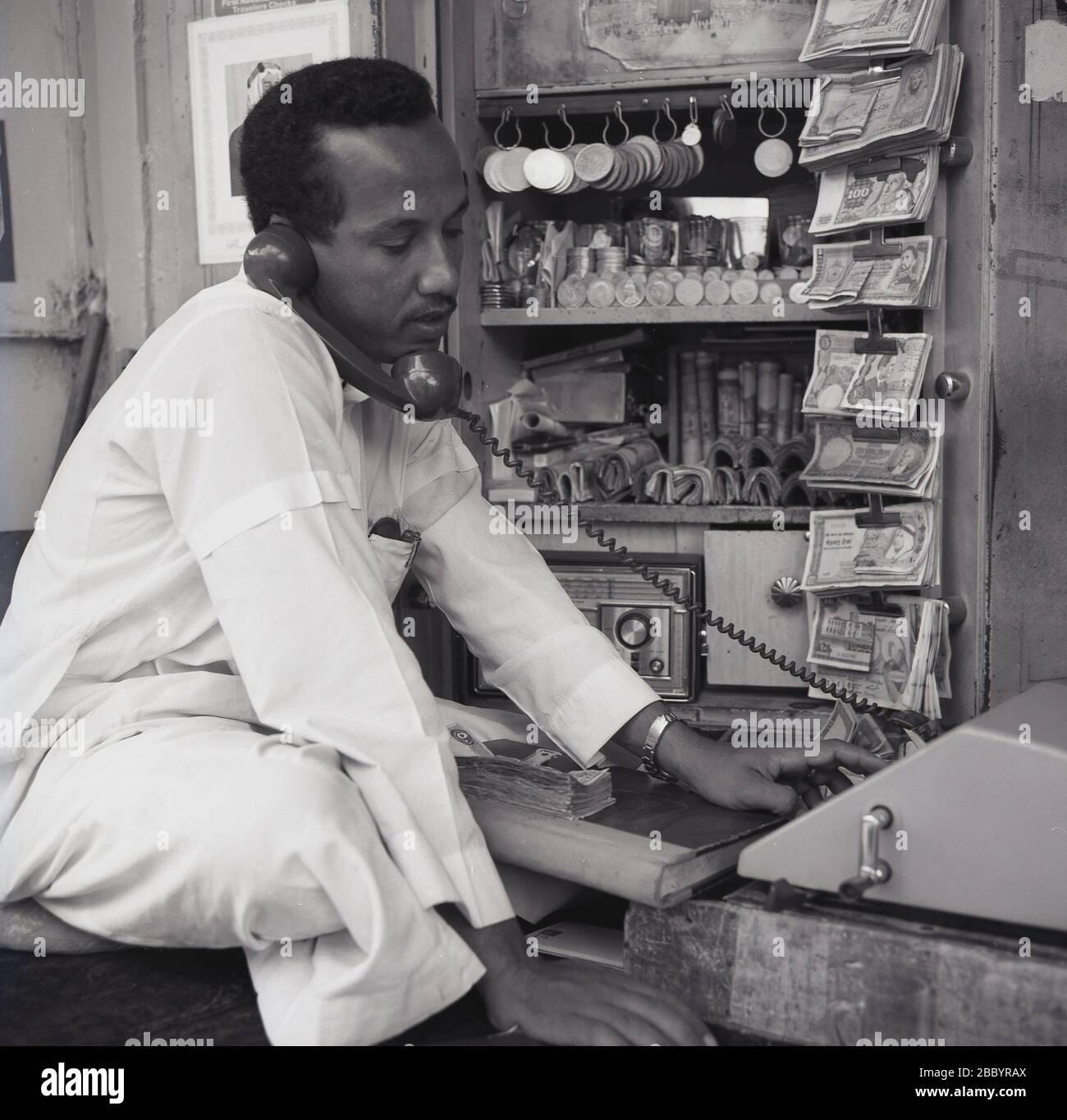 1960s, historical, money exchange, Saudi Arabia, a trader on a ...