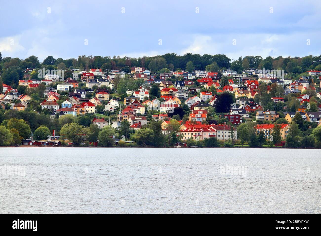 Swedish residential architecture. Lakeside colorful homes by lake ...