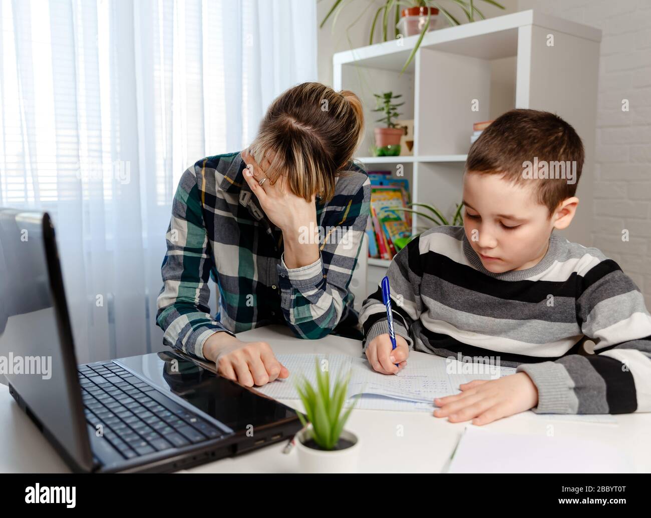 Women working from home with child. Homeschooling and freelance job ...