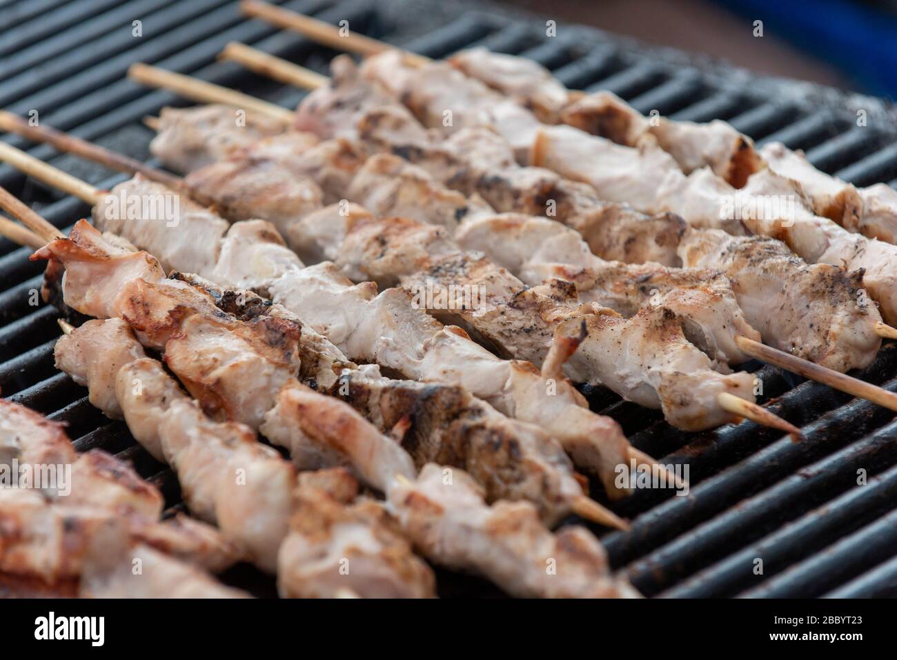 Meat skewers placed on an iron grill Stock Photo - Alamy