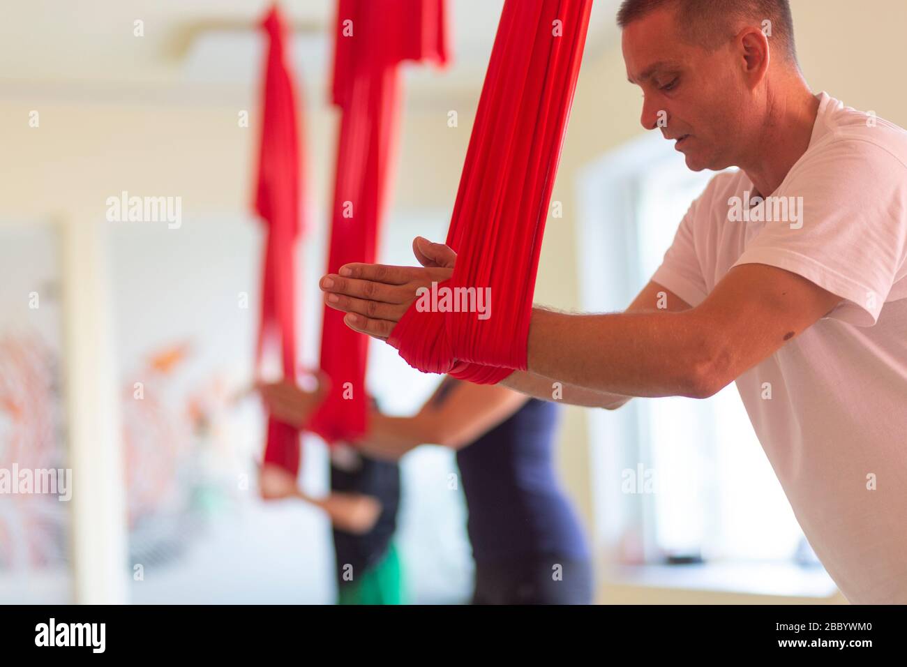 Aerial yoga class in progress Stock Photo - Alamy