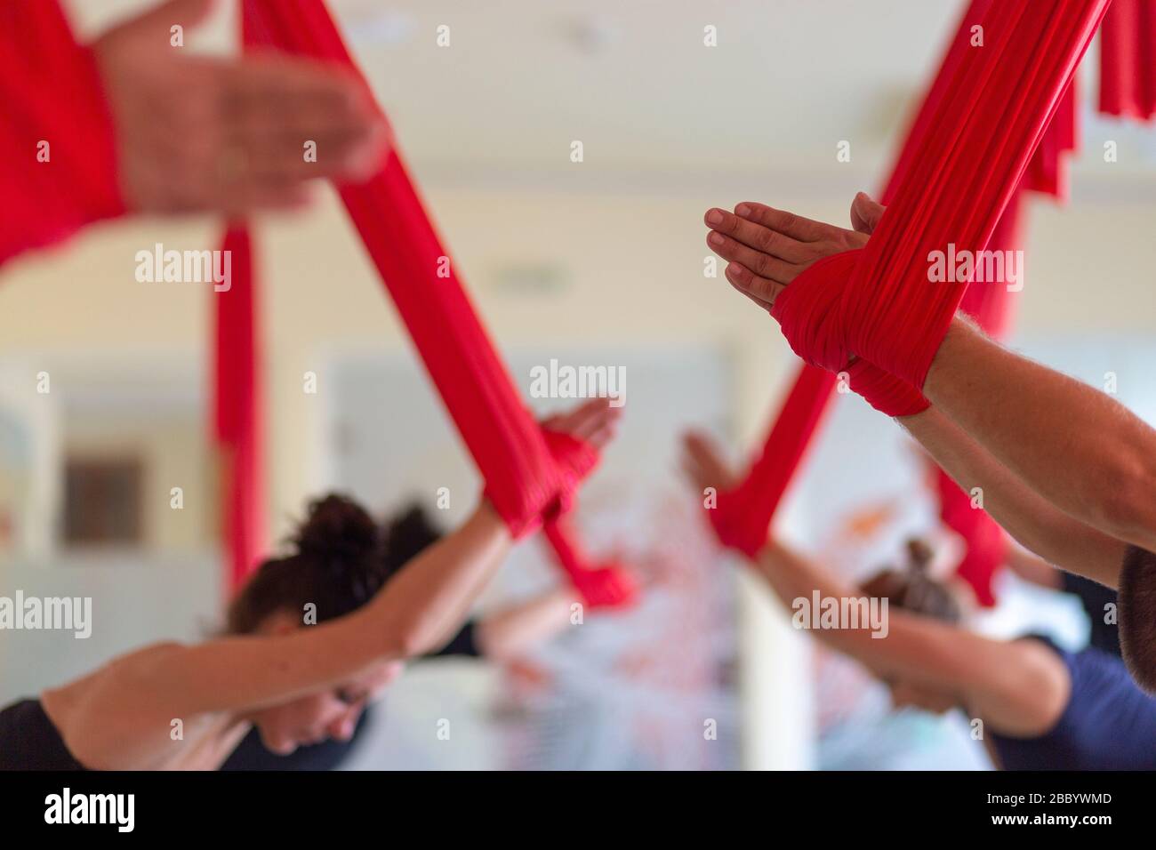 Aerial yoga class in progress Stock Photo - Alamy