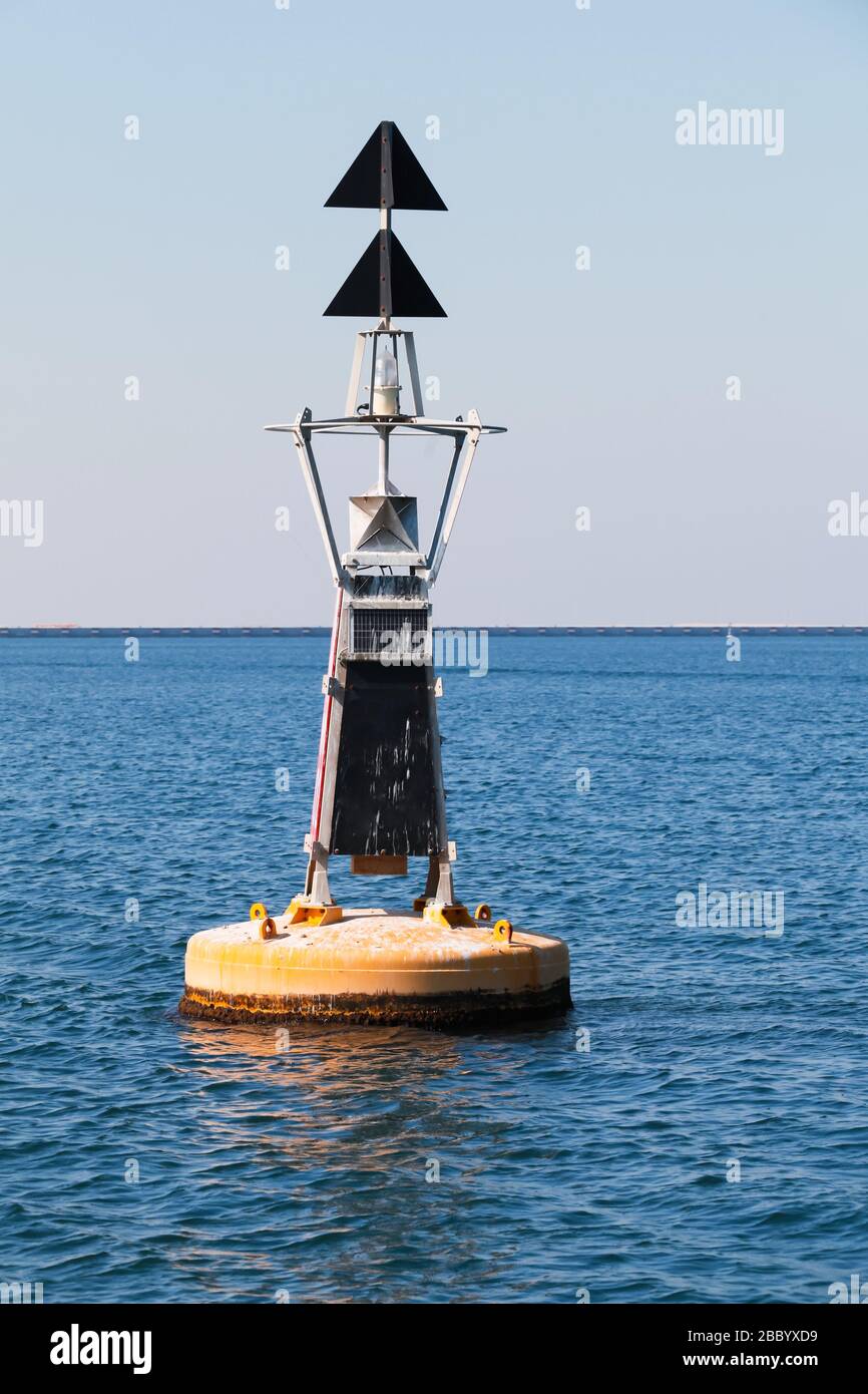Yellow black North Cardinal buoy is on water of Persian Gulf, Saudi ...