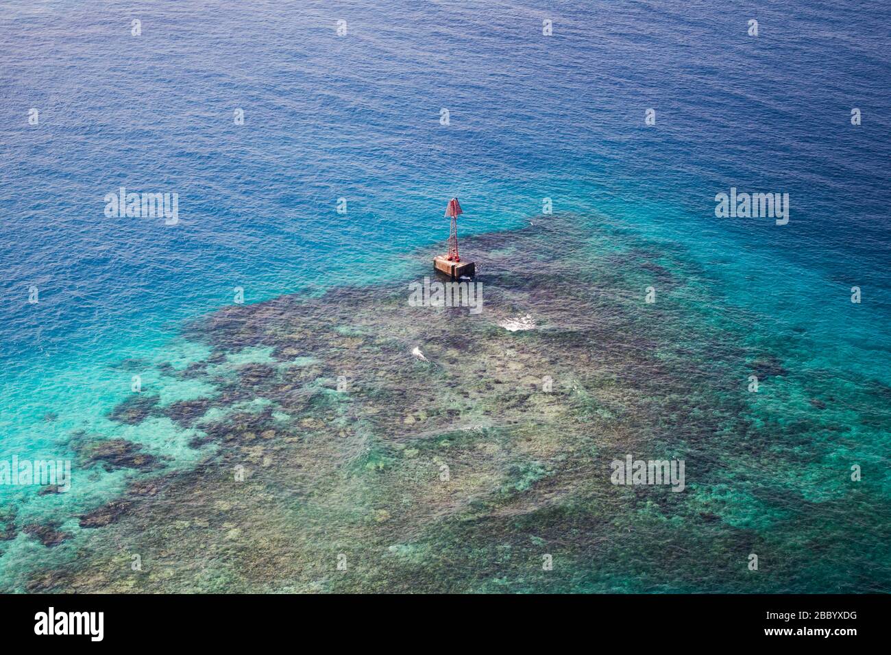 Red warning beacon with triangle top mark stands in water of Persian ...