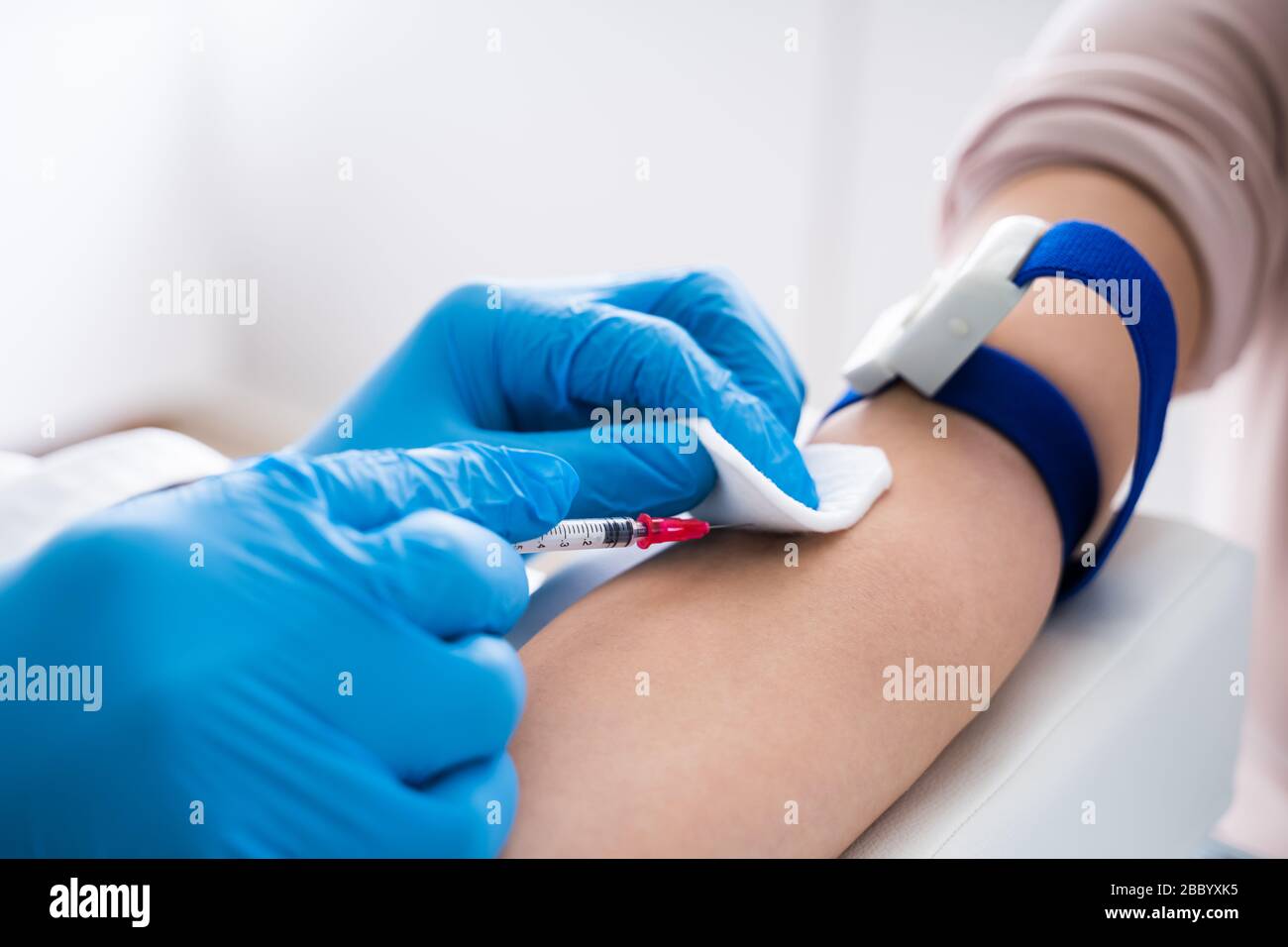 Close-up Of Female Doctor Injecting Male Patient With Syringe To ...