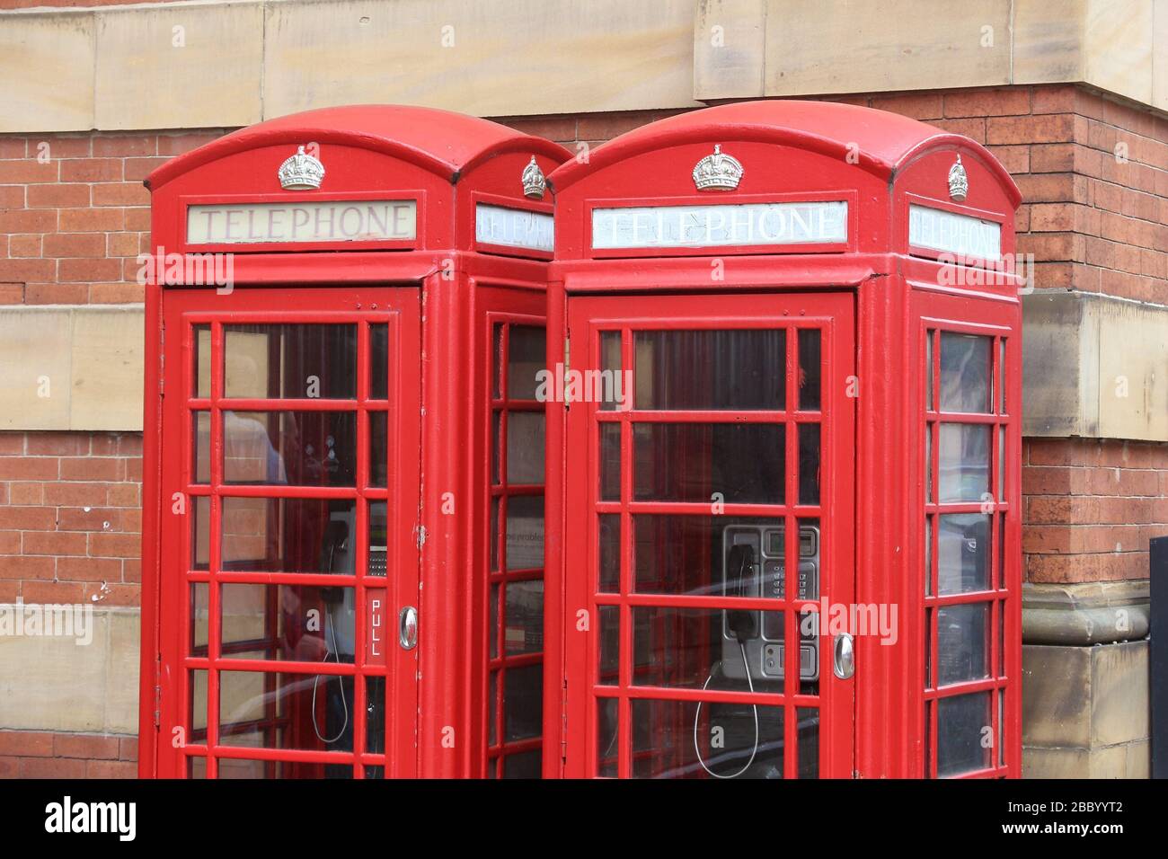 Leeds city in the UK. Red telephone booths Stock Photo - Alamy