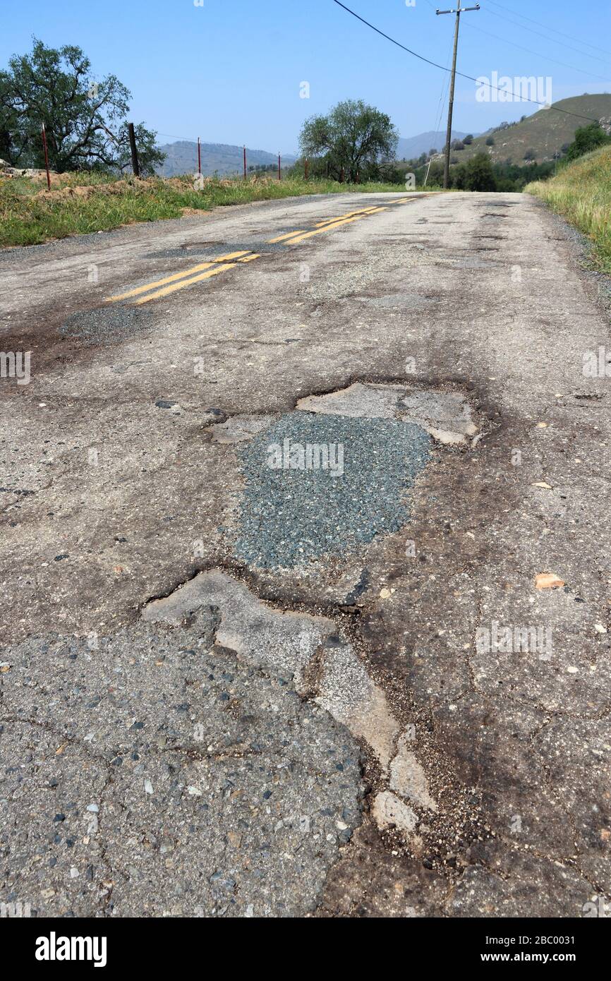 Pothole road - damaged roadway surface in California, USA Stock Photo ...