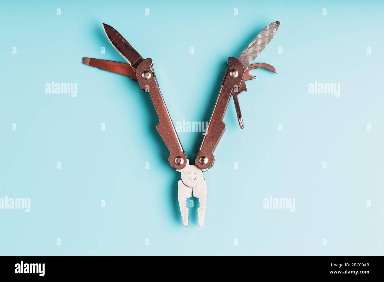 The multitool multi-function tool hovers on a blue background. The ...