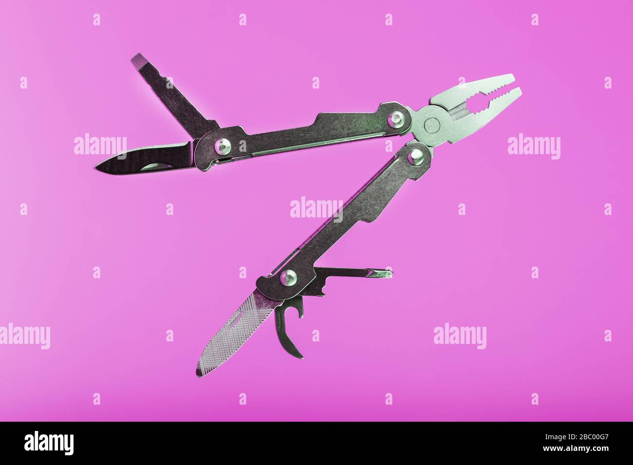 Multitool is a multi-functional tool on a pink background. The concept ...