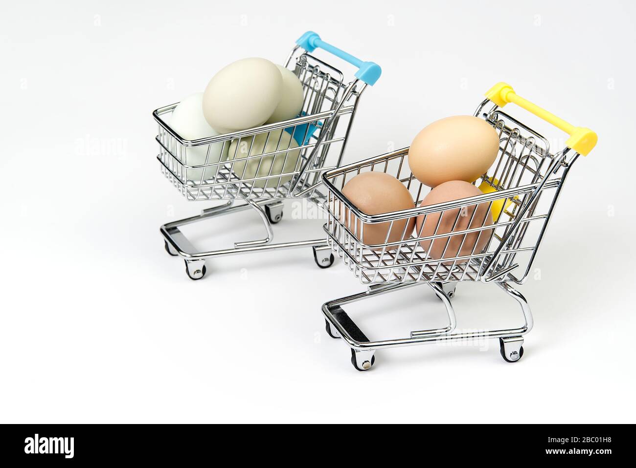 chicken colored eggs in a shopping cart. isolated on white Stock Photo ...