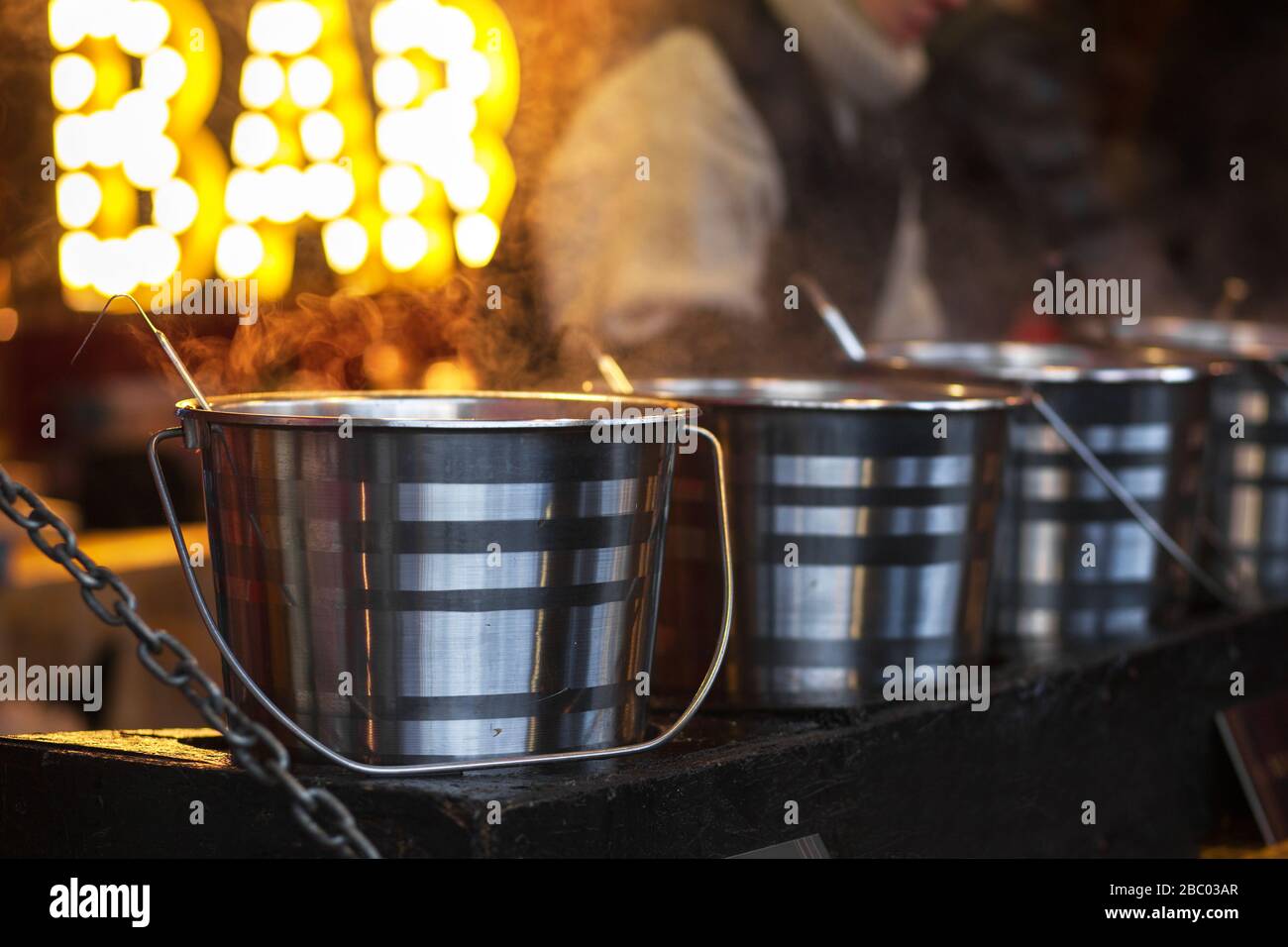 Street food. Hot mulled wine. Thick steam over buckets of hot wine ...