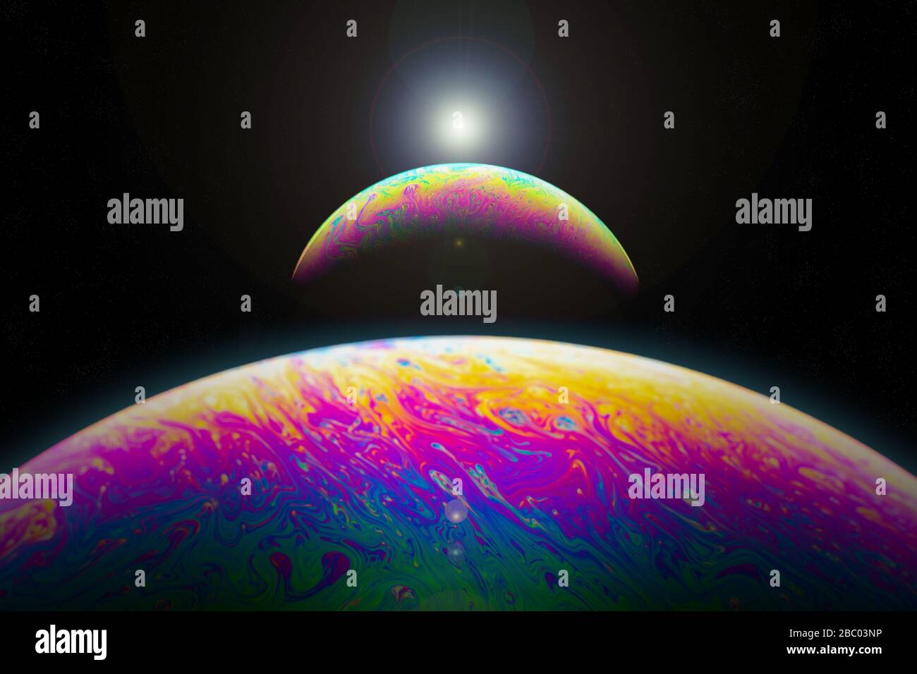 Macrophotograph of a colorful soap bubble looking like a planet with a ...