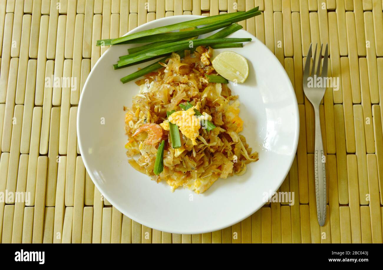 Pad Thai stir fried rice noodles with egg and yellow tofu on plate ...