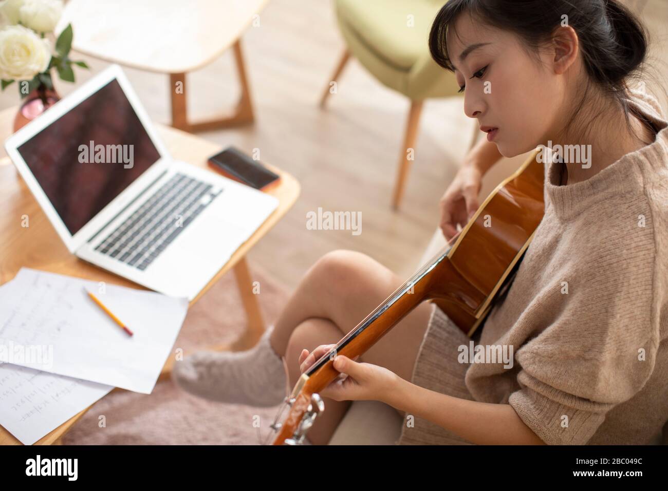 Young Chinese woman writing music at home Stock Photo - Alamy