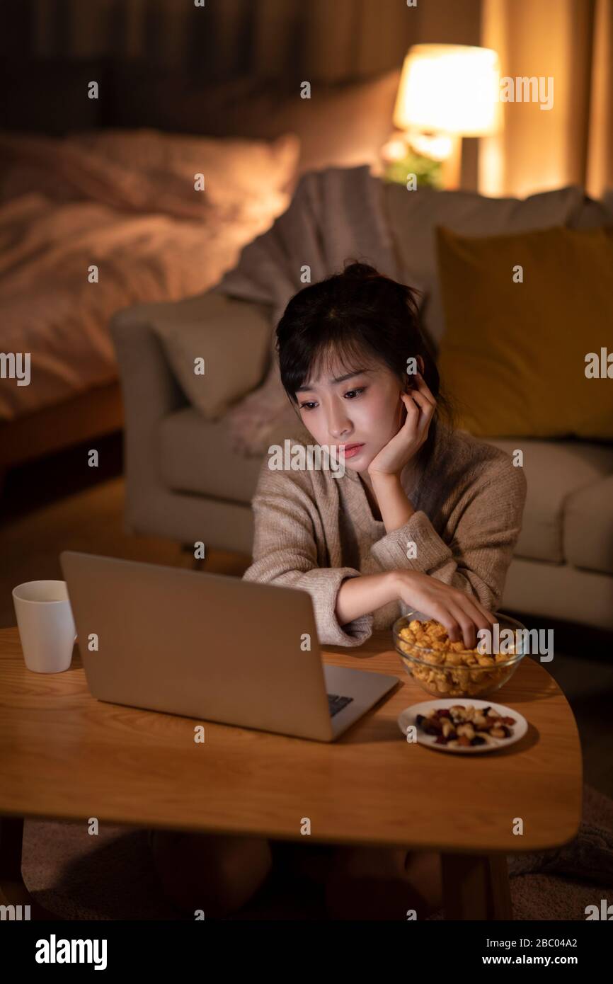 Young Chinese woman watching movie on laptop Stock Photo - Alamy