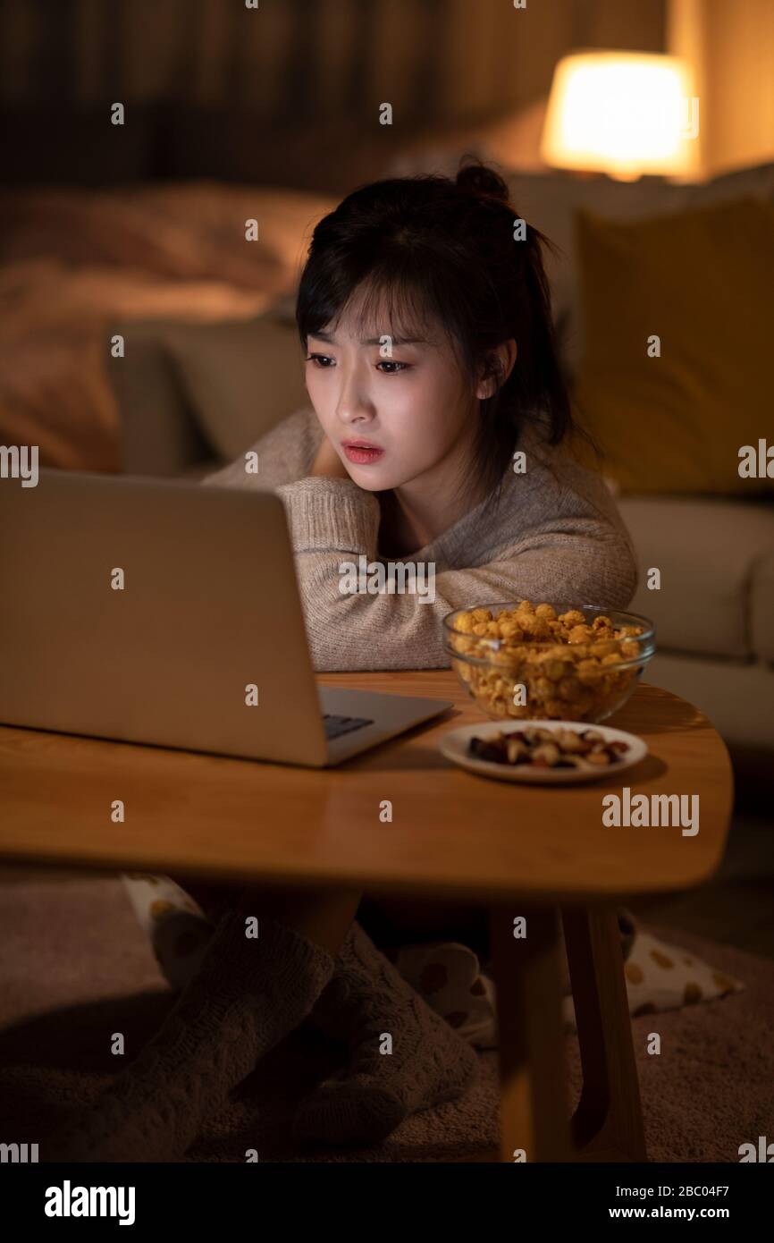 Young Chinese woman watching movie on laptop Stock Photo - Alamy