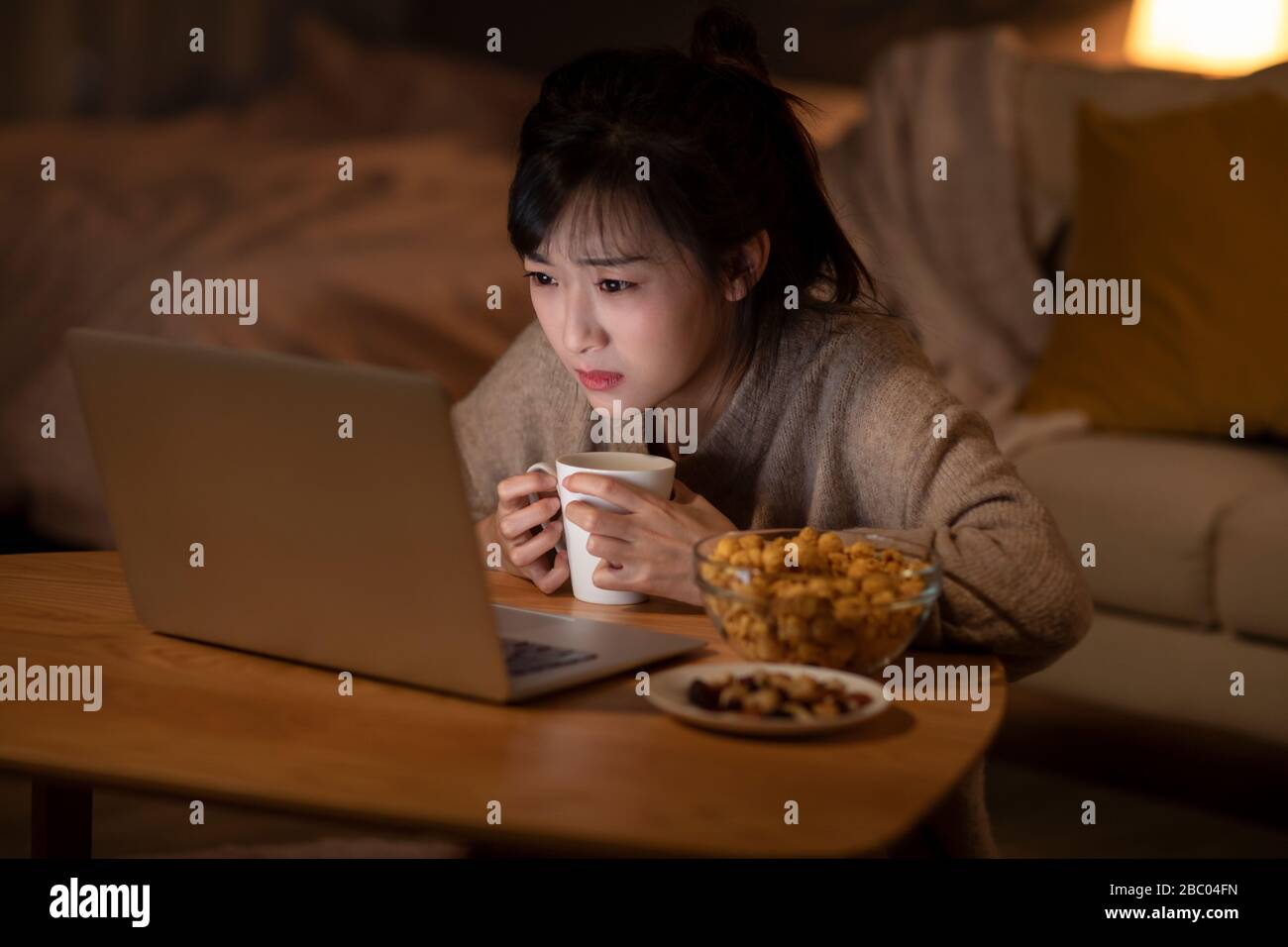 Young Chinese woman watching movie on laptop Stock Photo - Alamy