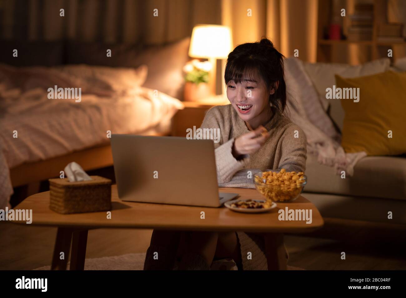Young Chinese woman watching movie on laptop Stock Photo - Alamy