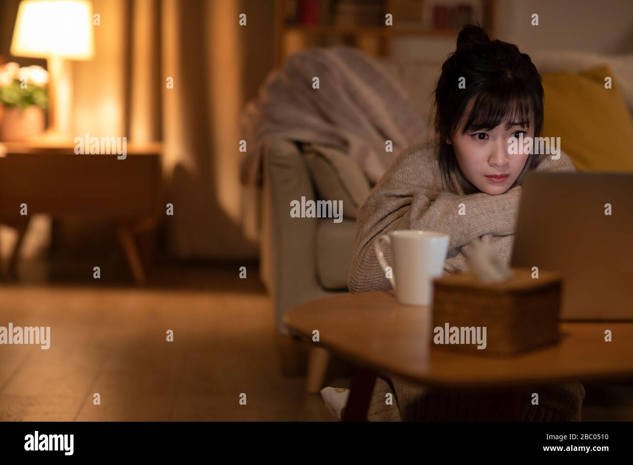 Young Chinese woman watching movie on laptop Stock Photo - Alamy