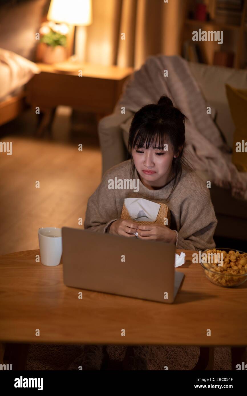 Young Chinese woman watching movie on laptop Stock Photo - Alamy