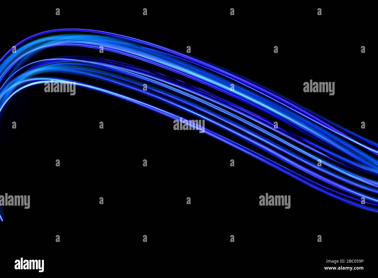 Long exposure photograph of neon colour in an abstract swirl, parallel ...
