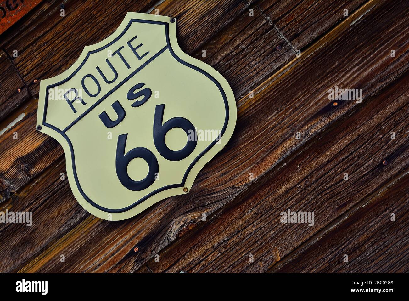 Historic U.S. old Route 66 sign with wooden background Stock Photo - Alamy