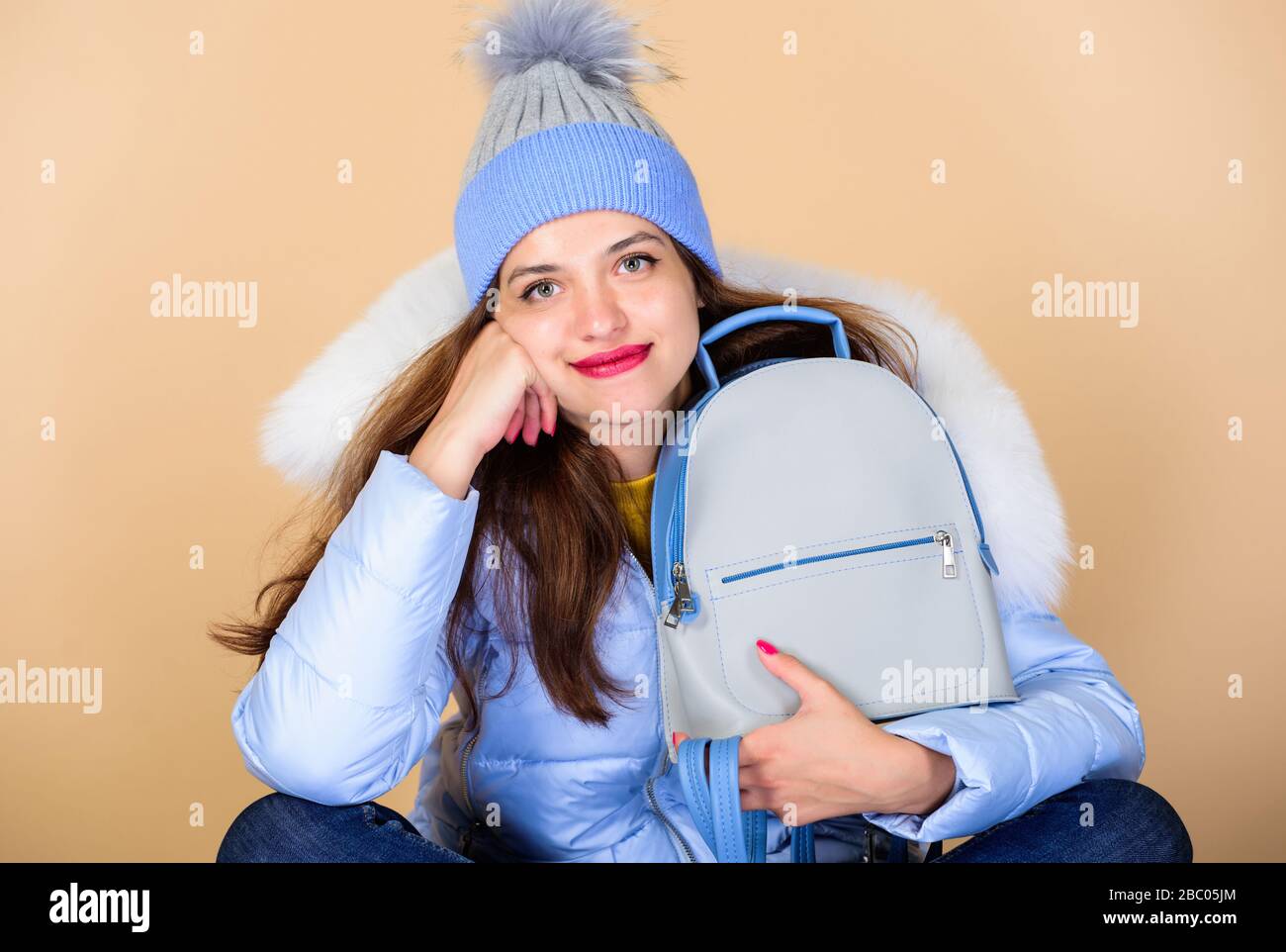 Fashion accessory. Little backpack and knitted hat. Total pastel outfit ...