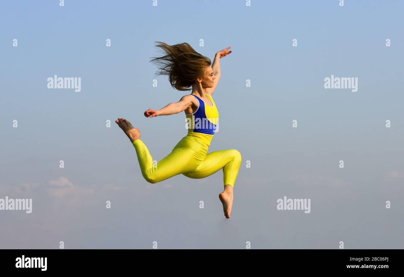 girl jumping high. sport in motion. full of energy. Attractive young ...