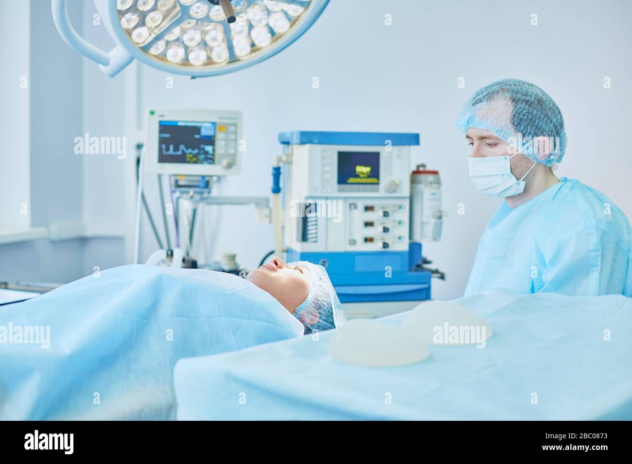 Several doctors surrounding patient on operation table during their ...