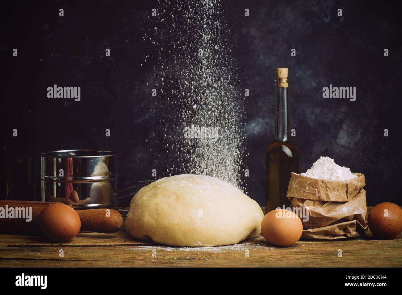 Pizza dough cooking in the home kitchen. Homemade dough for bread ...