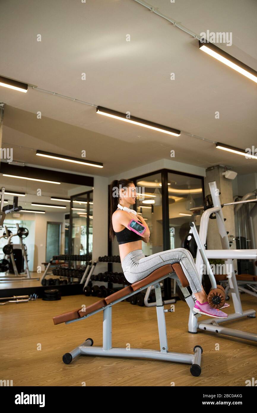 Pretty young woman have a training at sit up bench in the gym Stock ...
