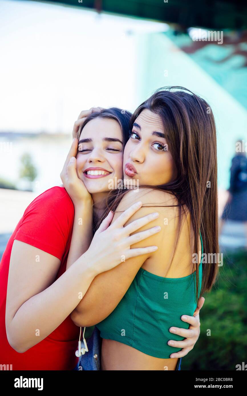 Two best female friends embracing together outdoors Stock Photo - Alamy