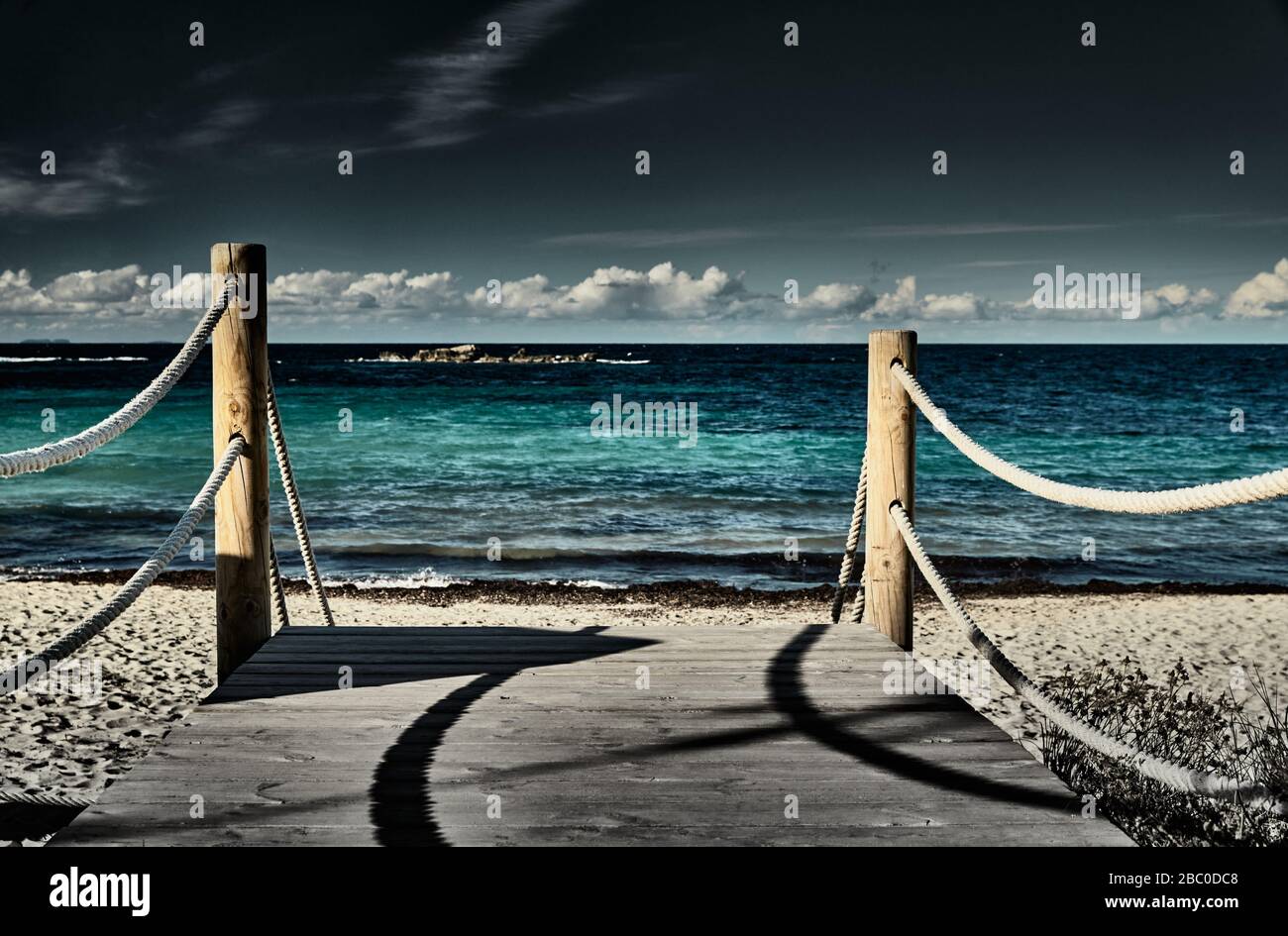 The path to a sea beach, a path consists of wooden boards, on each side ...