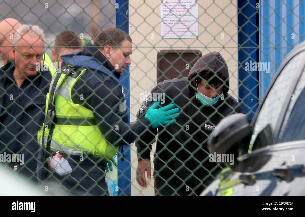 Border force officers process men thought hi-res stock photography and ...
