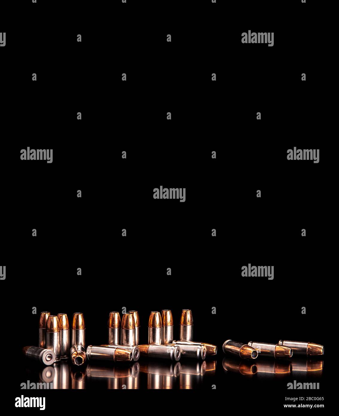 Bullet isolated on black background with reflexion. Rifle bullets close ...