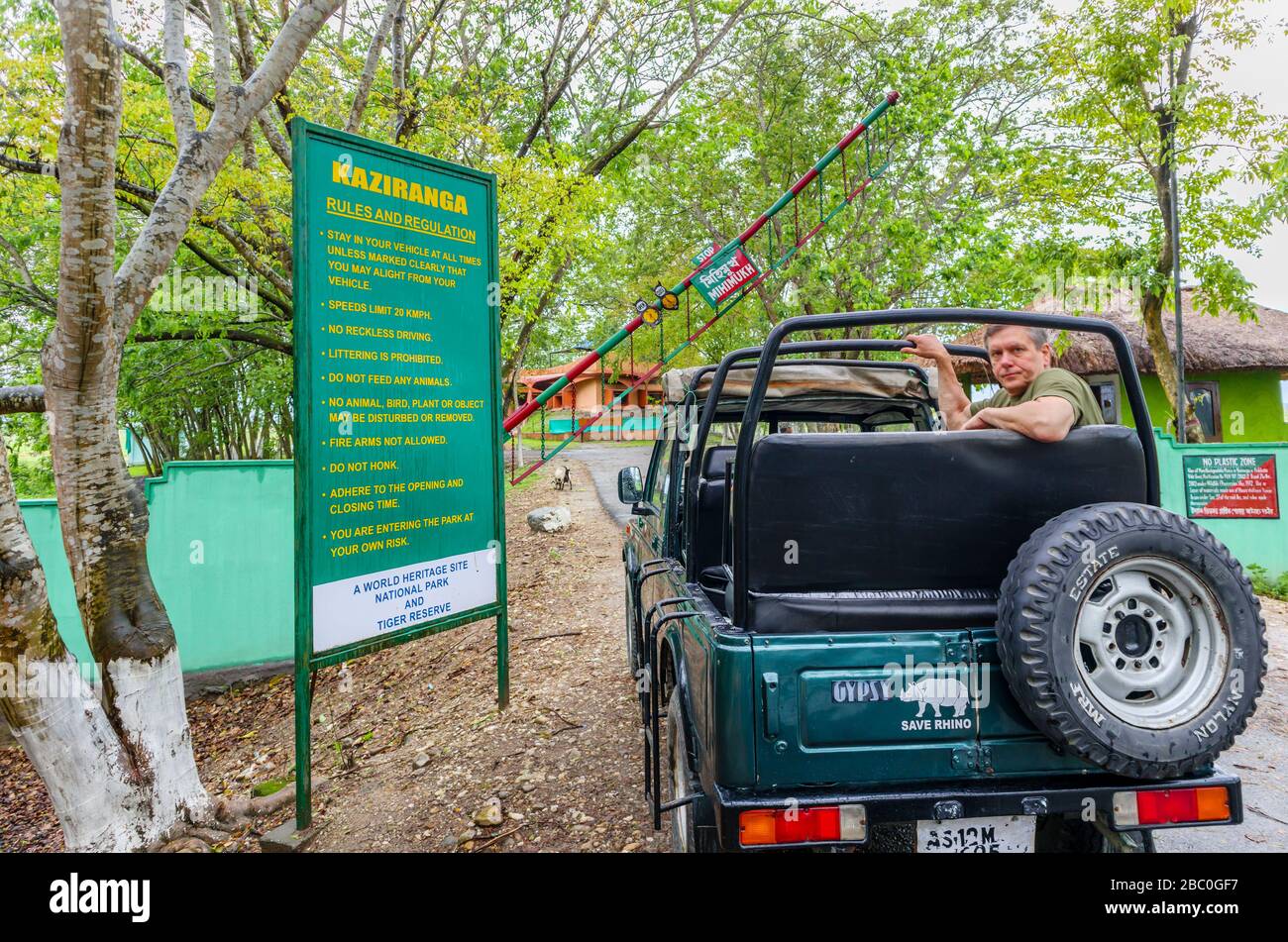 Green Gypsy safari vehicle waiting by a Rules and Regulation sign in ...