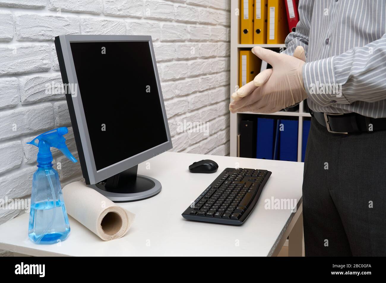 concept of cleaning or disinfecting the office - a businessman cleans ...