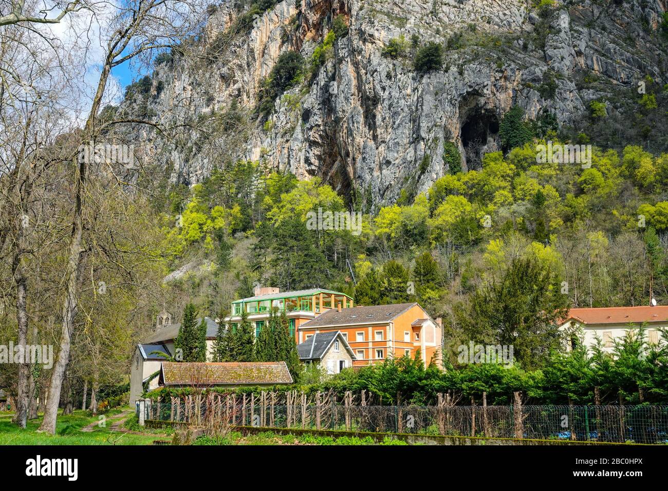 Hotel and spa, French-style buildings surrounded by cliffs and caves ...