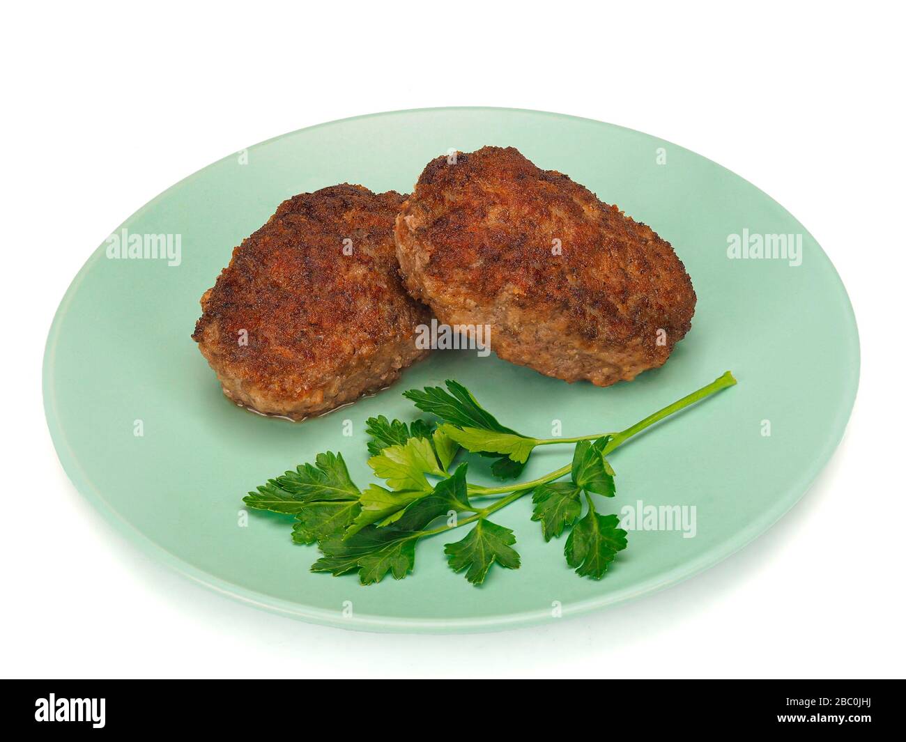 Homemade cutlets on a plate and white background Stock Photo - Alamy