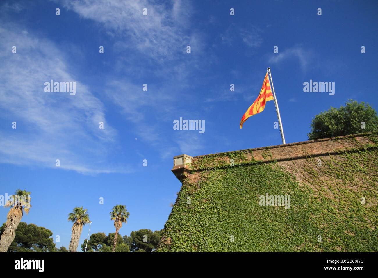 A view at the Catalonian Flag against a blue sky on the army fortress ...