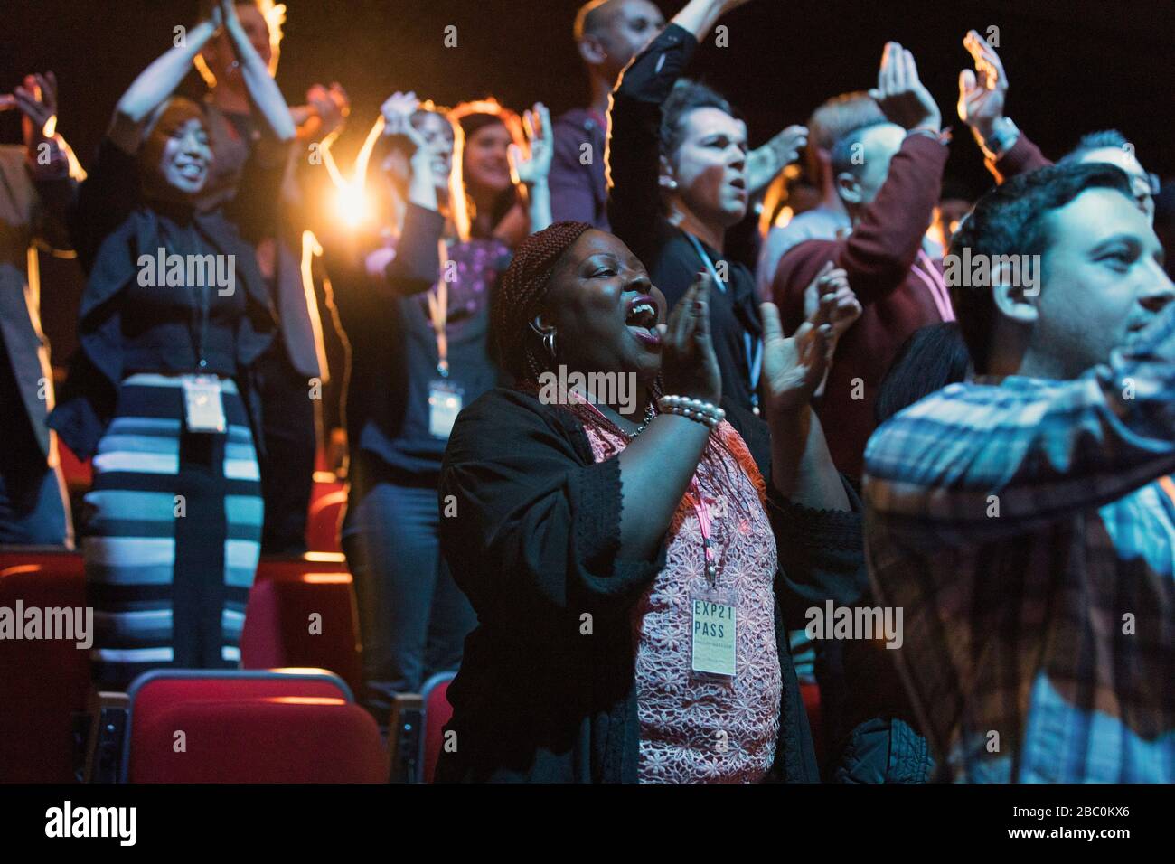 Audience clapping and cheering in dark concert hall Stock Photo - Alamy