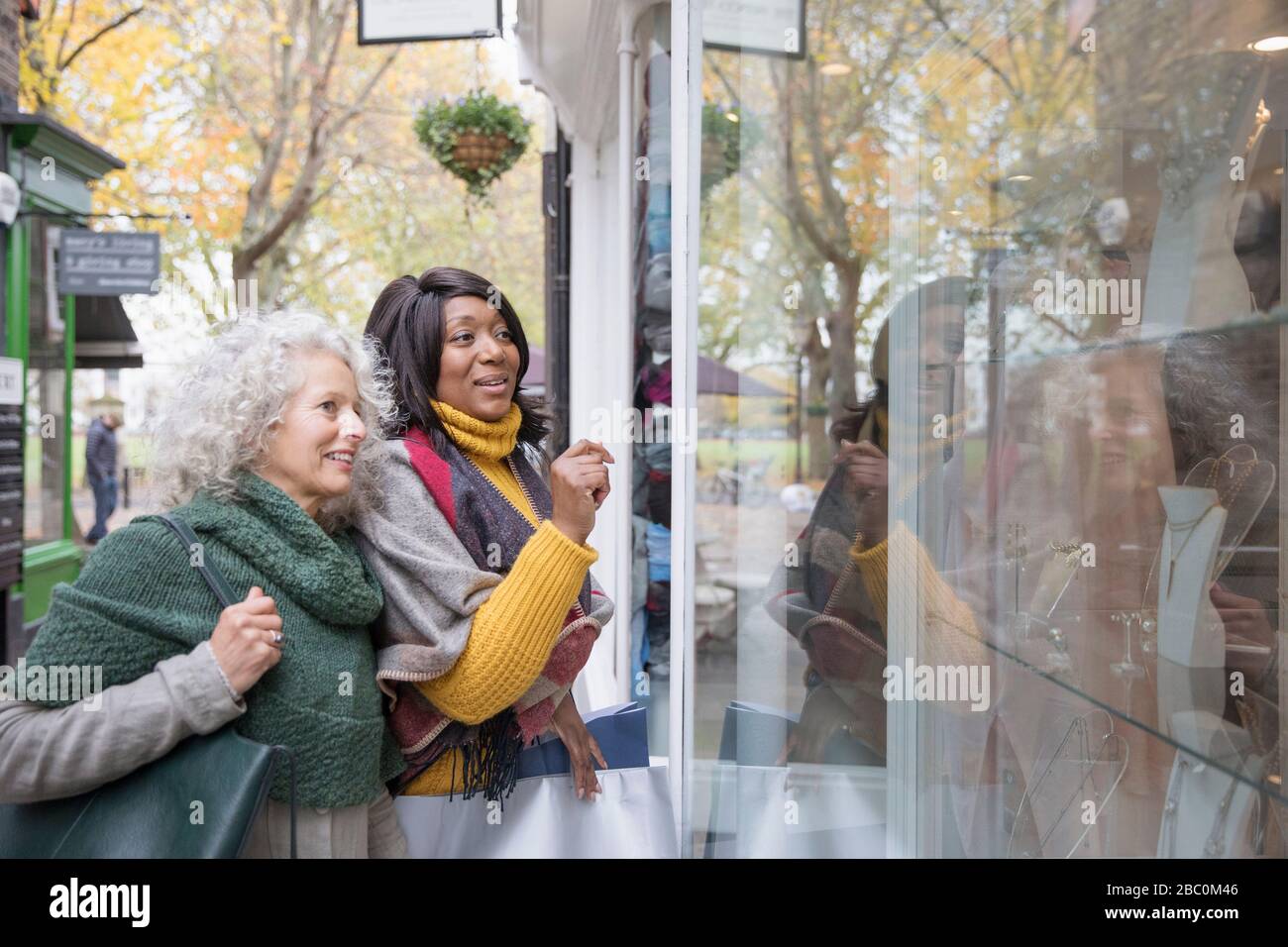 Senior women window shopping at urban storefront Stock Photo - Alamy
