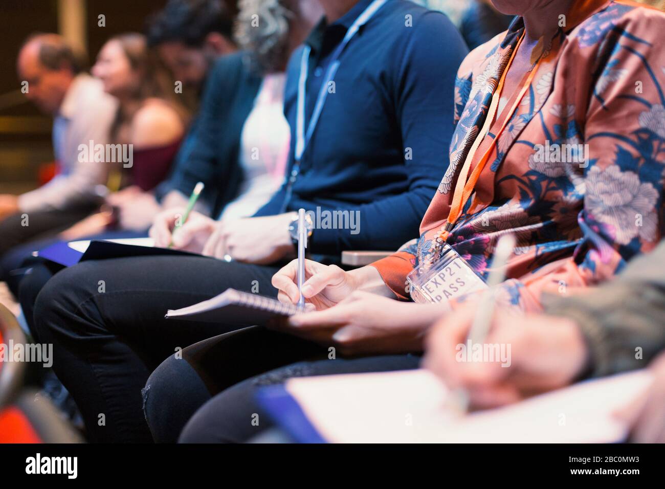 Business people taking notes in conference audience Stock Photo - Alamy