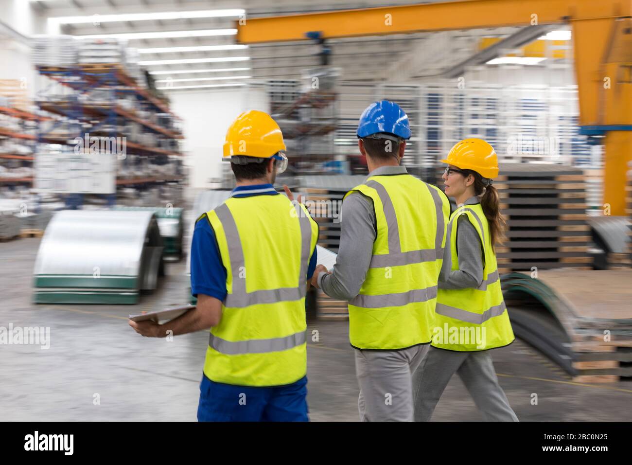 Workers walking and talking in factory Stock Photo - Alamy