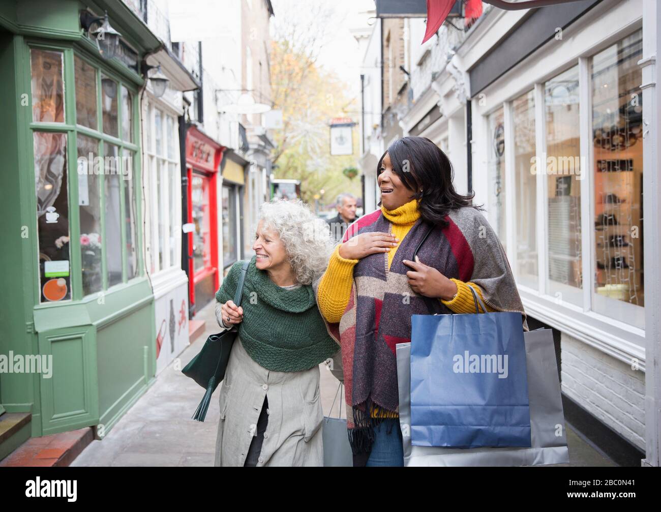 Senior women friends window shopping outside storefront Stock Photo - Alamy