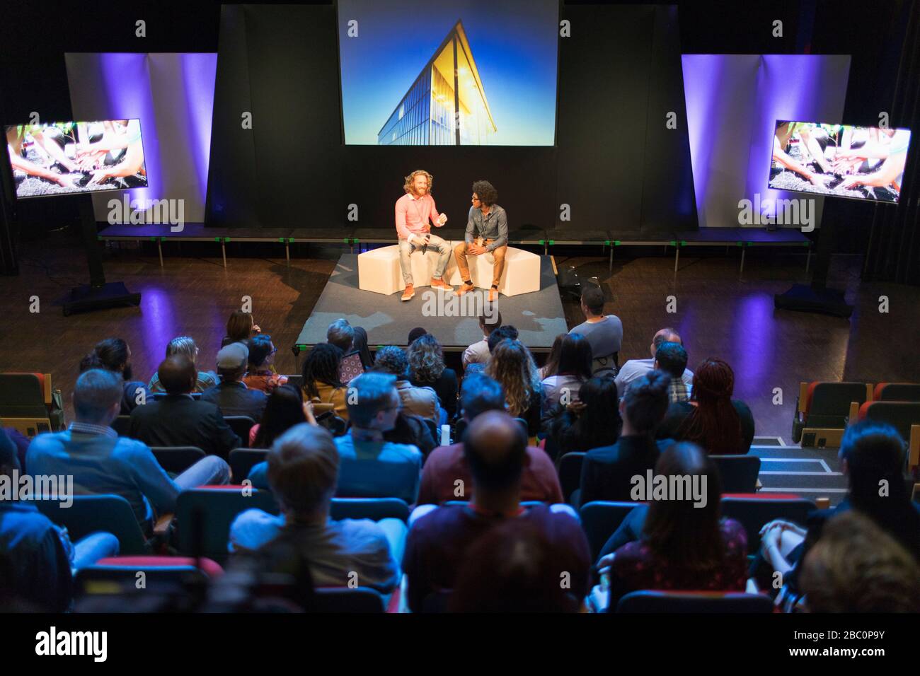 Audience watching speakers on stage Stock Photo - Alamy