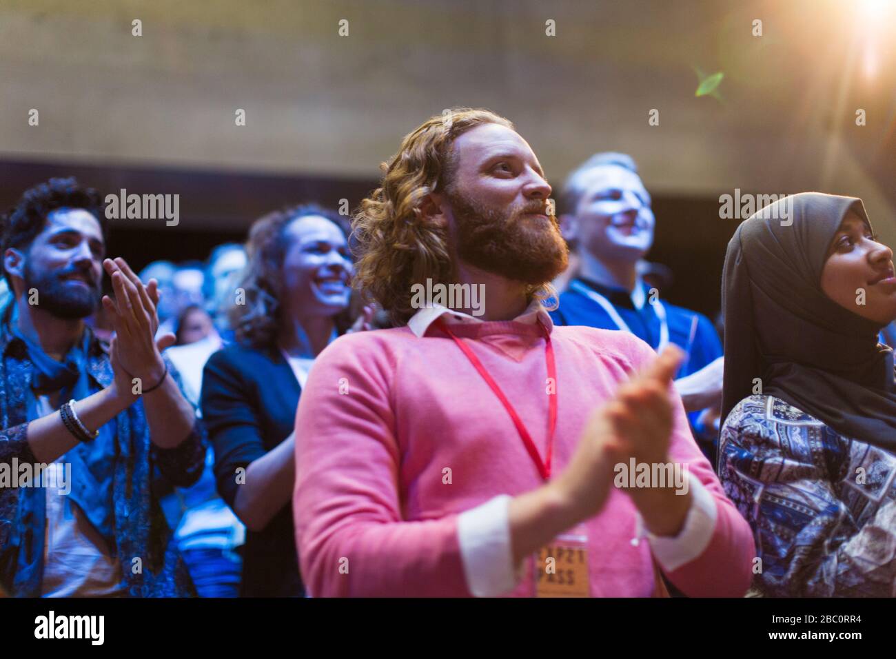 Smiling man clapping in audience Stock Photo - Alamy